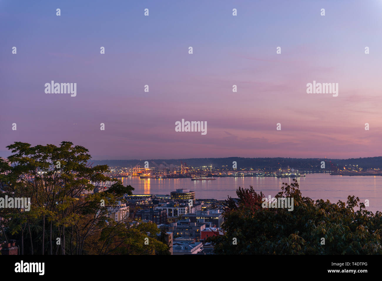 The sky takes on a purple tone at dusk in the port of Seattle and ...