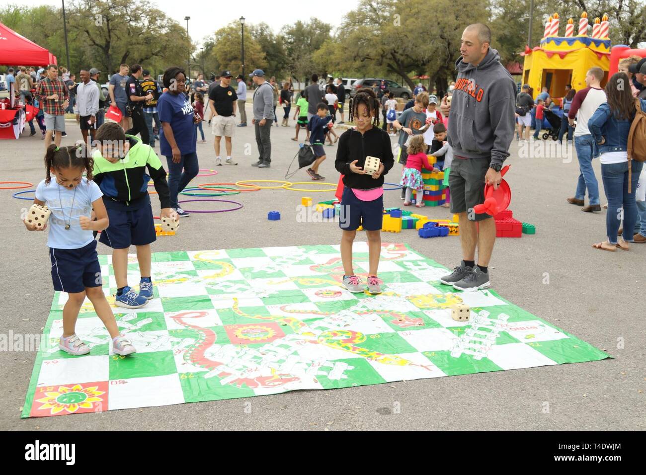 Troopers and families with the 3rd Cavalry Regiment enjoy playing games ...
