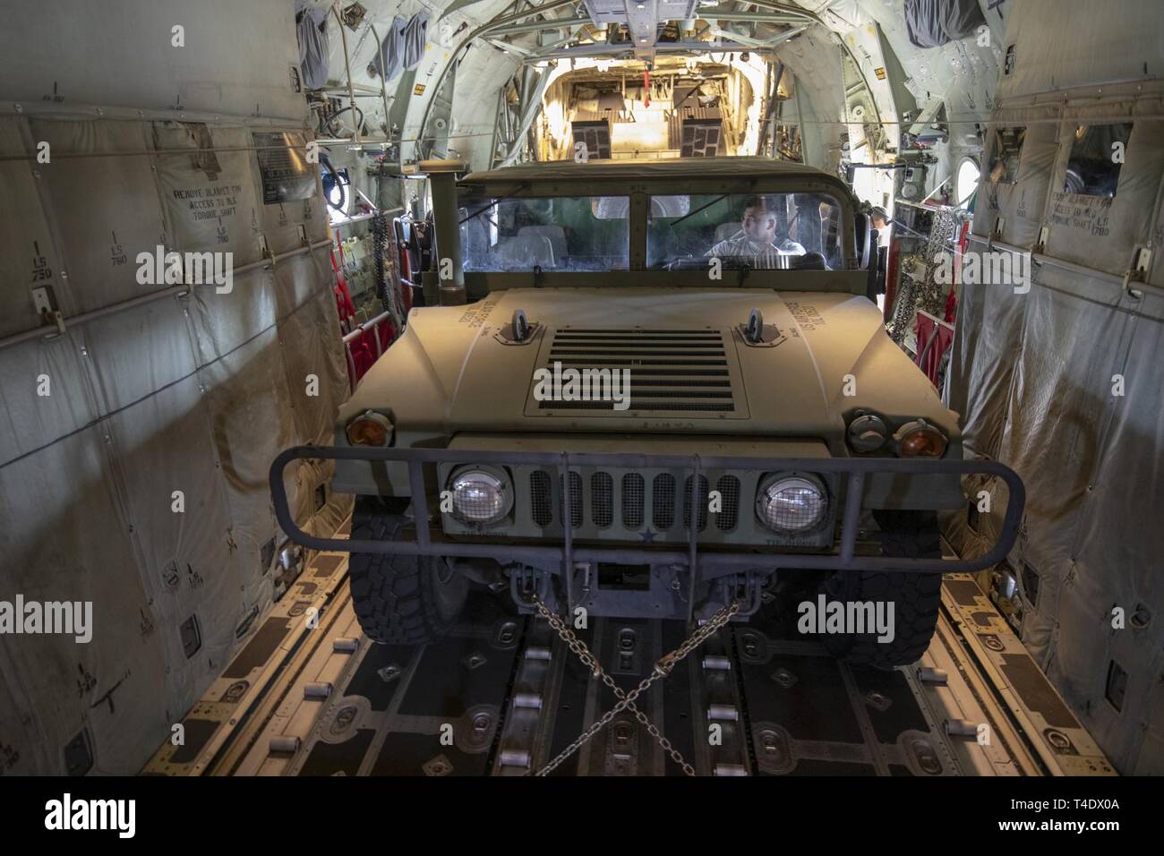 An Air Force Humvee vehicle sits strapped down in a C-130J Super ...