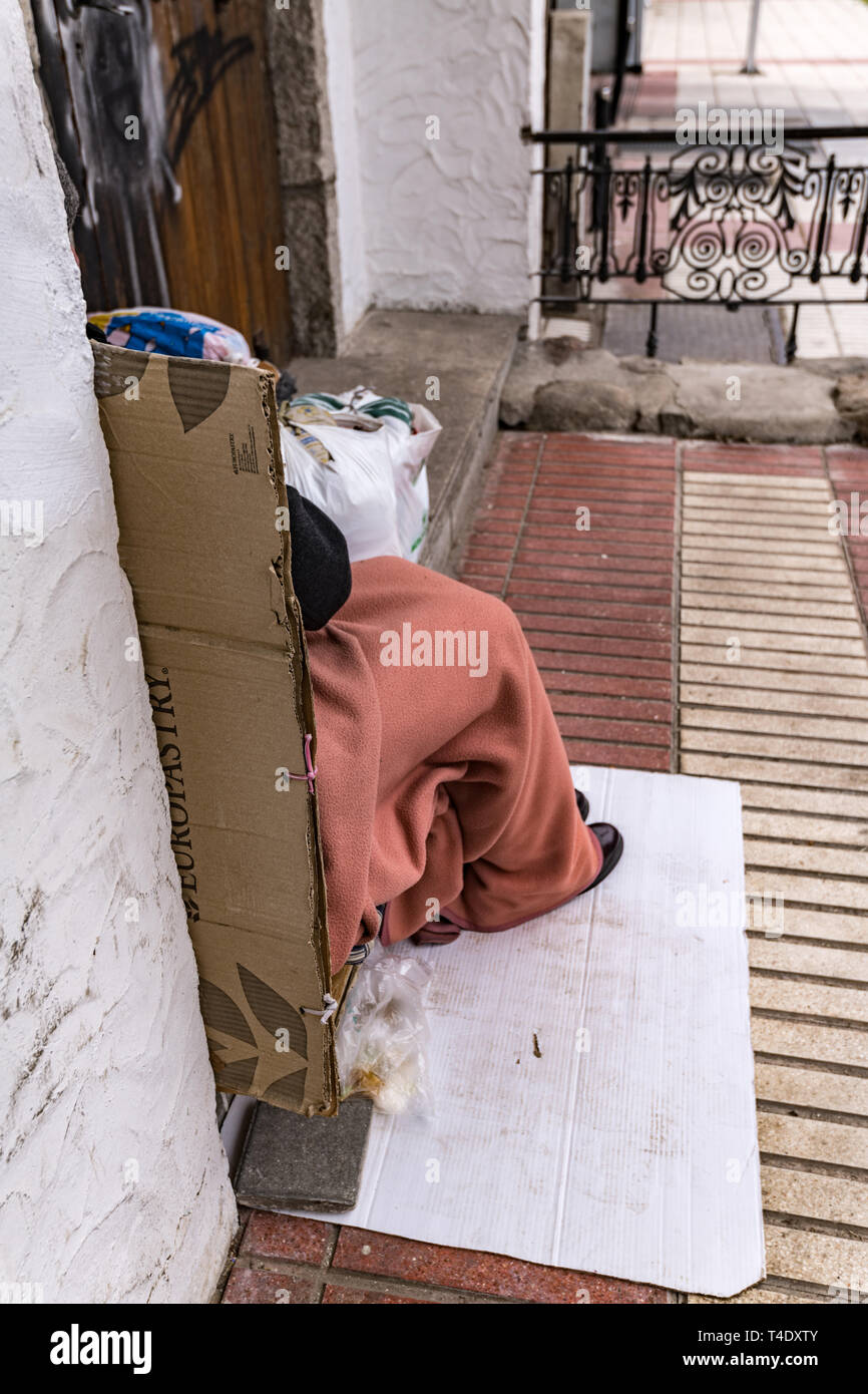 homeless person with cardboard Stock Photo - Alamy