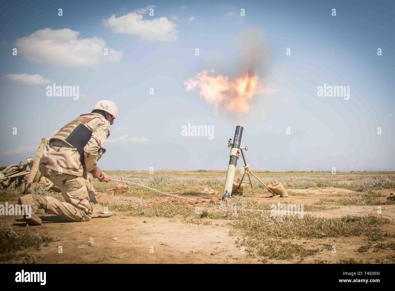 An Iraqi soldier fires a M74 light mortar for a live-fire exercise at ...