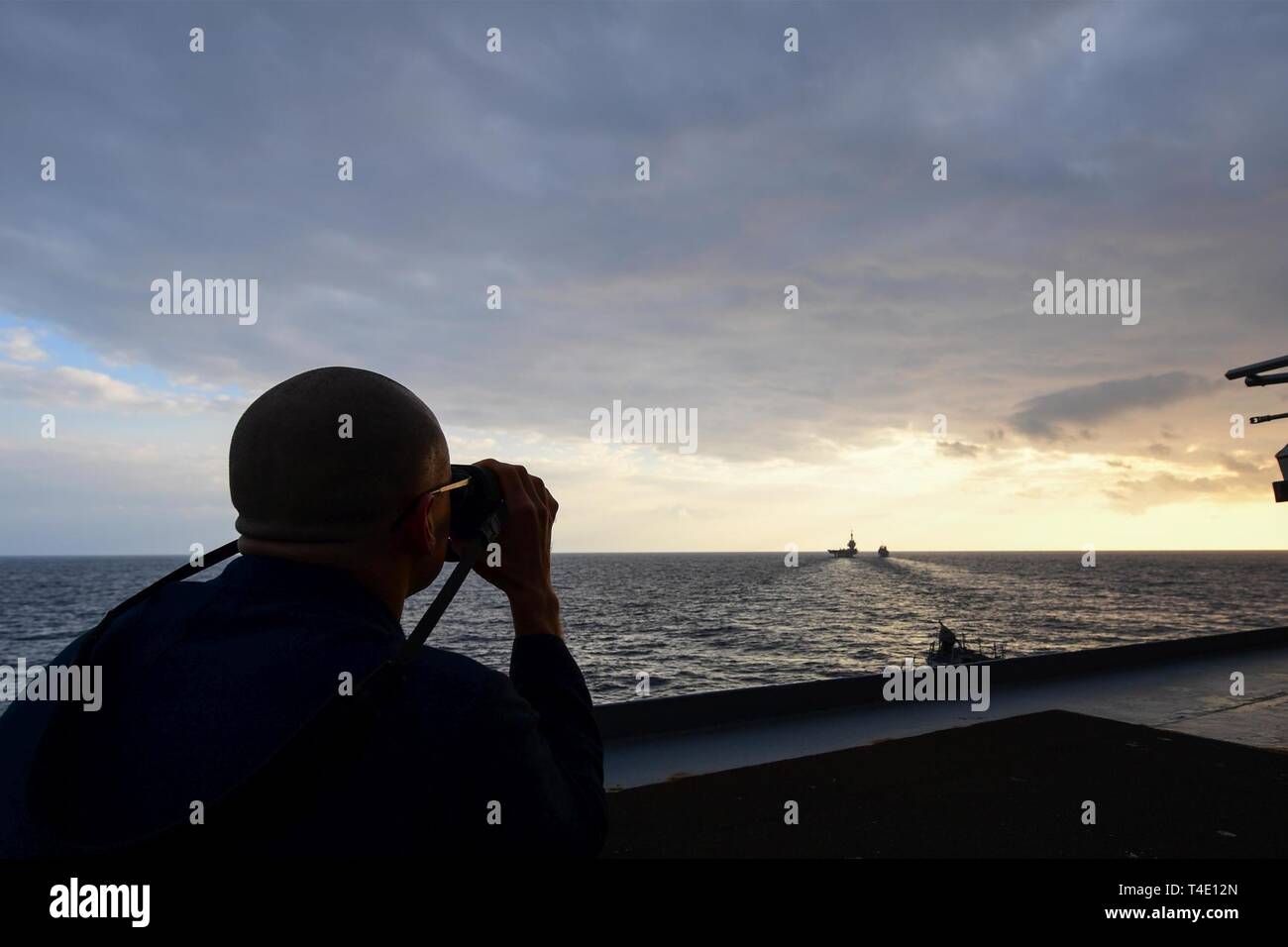 SEA (March 26, 2019) - Lt. j.g. Eric Strobach measures the distance ...