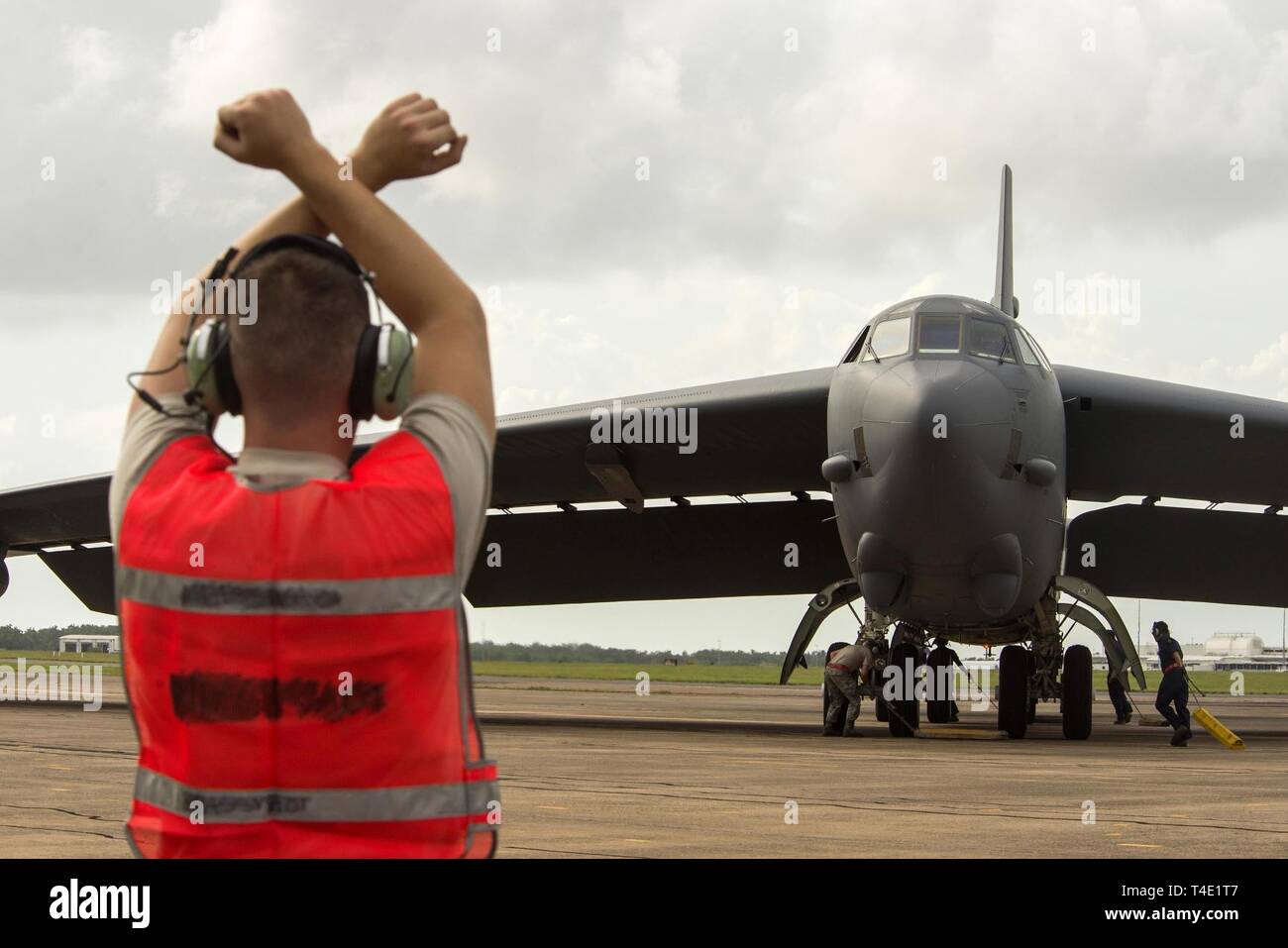 A U.S. Airman assigned to the 5th Maintenance Group marshals a B-52 Stratofortress during ...