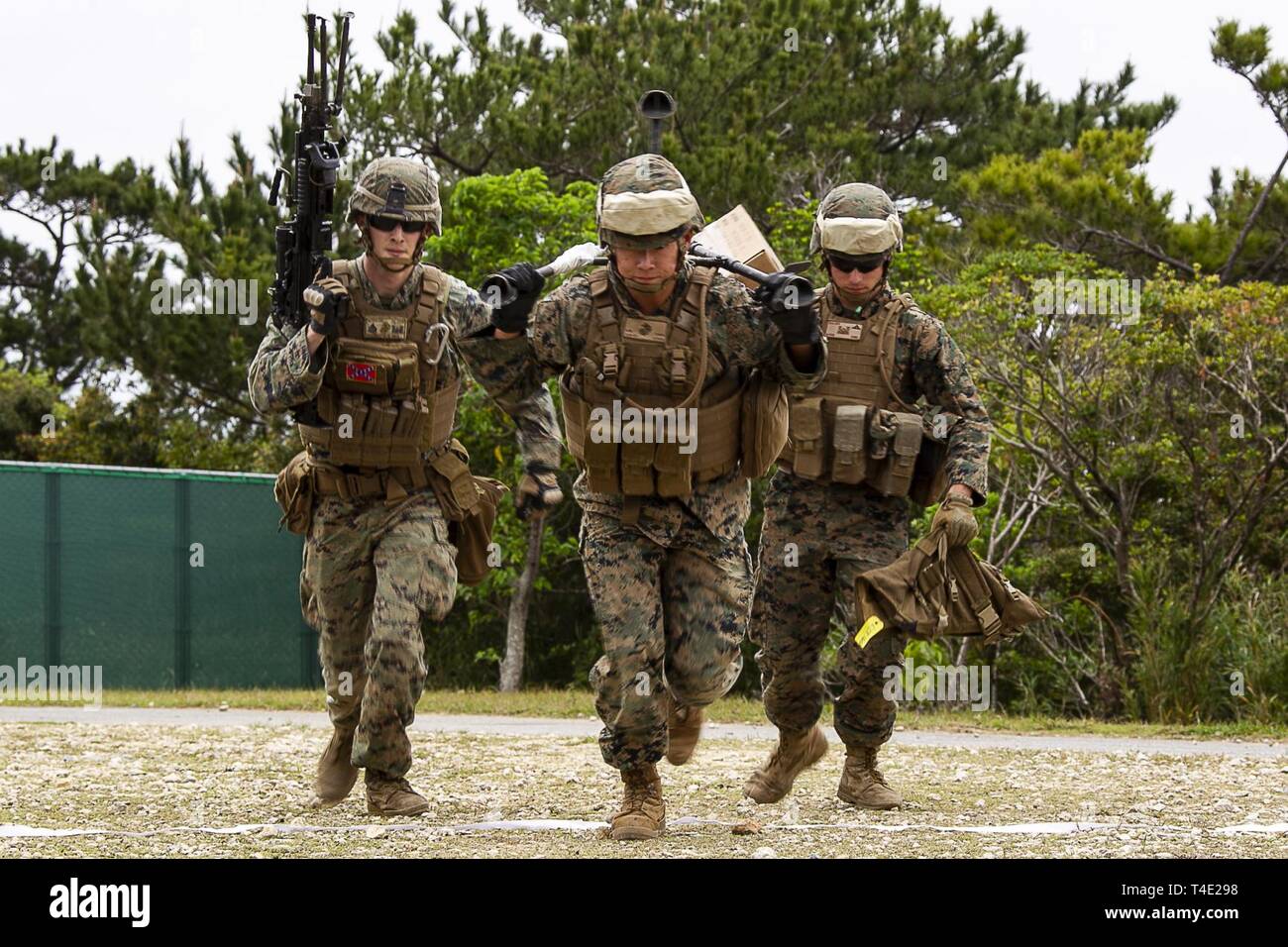 Marines with Combat Logistics Battalion 31 rush toward a firing ...