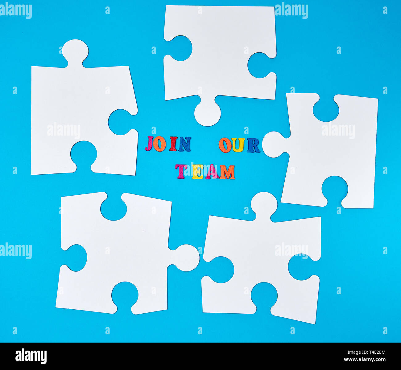 paper blank white puzzle on a blue background, the inscription join our ...