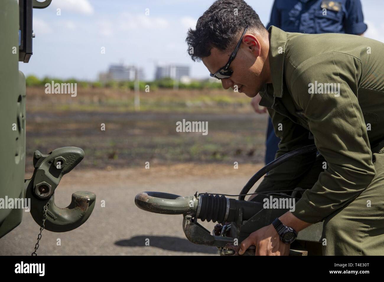 U.S. Marine Corps Lance Cpl. Ramon Mendoza detaches an M-31 arresting ...