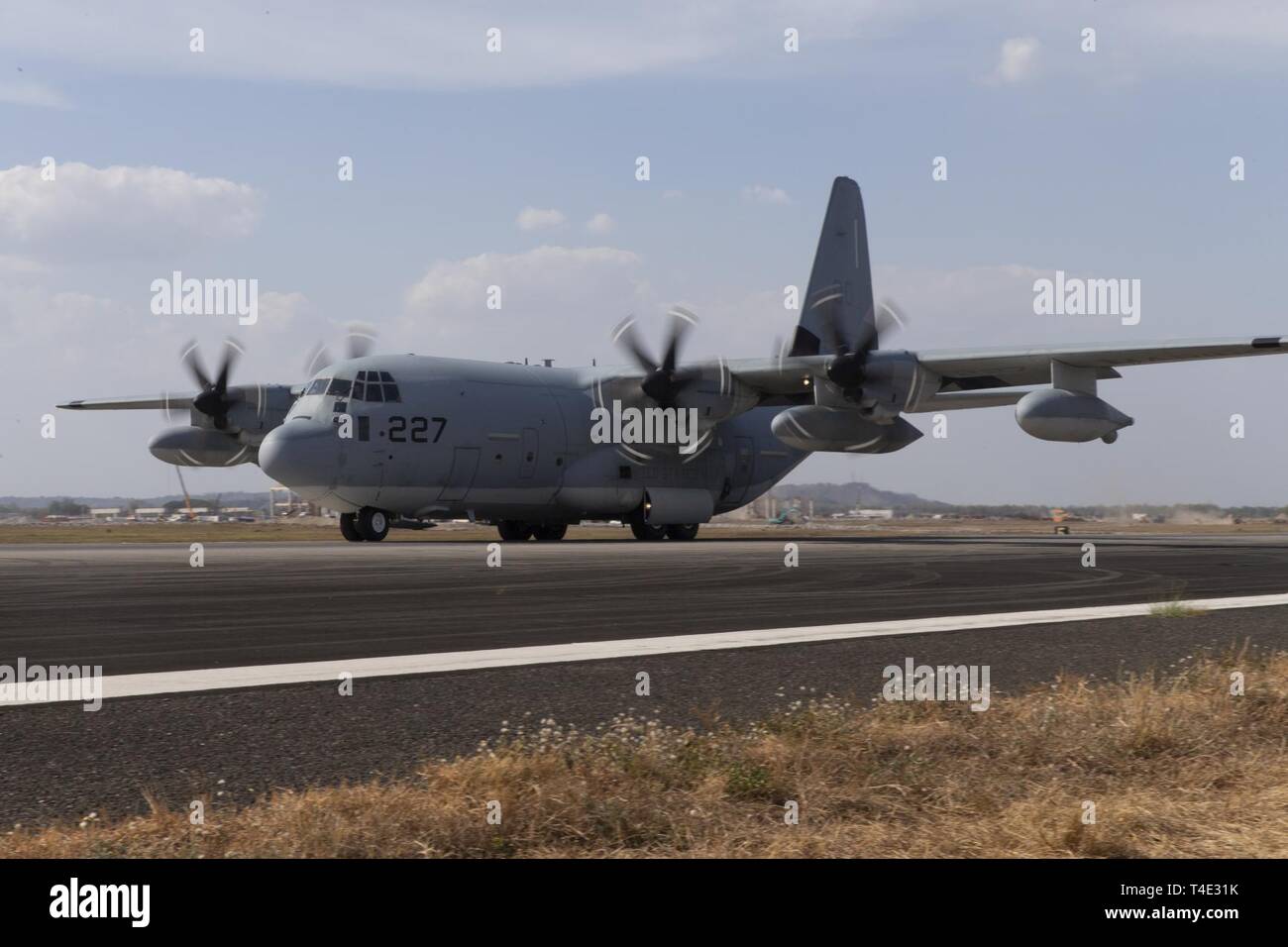 A U.S. Marine Corps KC-130J Super Hercules with Marine Refueler ...
