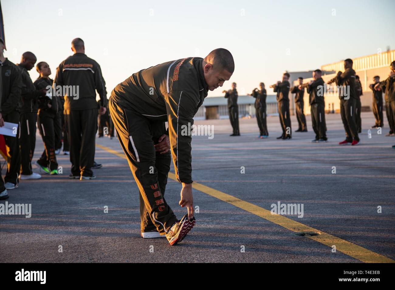 U.S. Marines perform various stretches prior to conducting unit ...