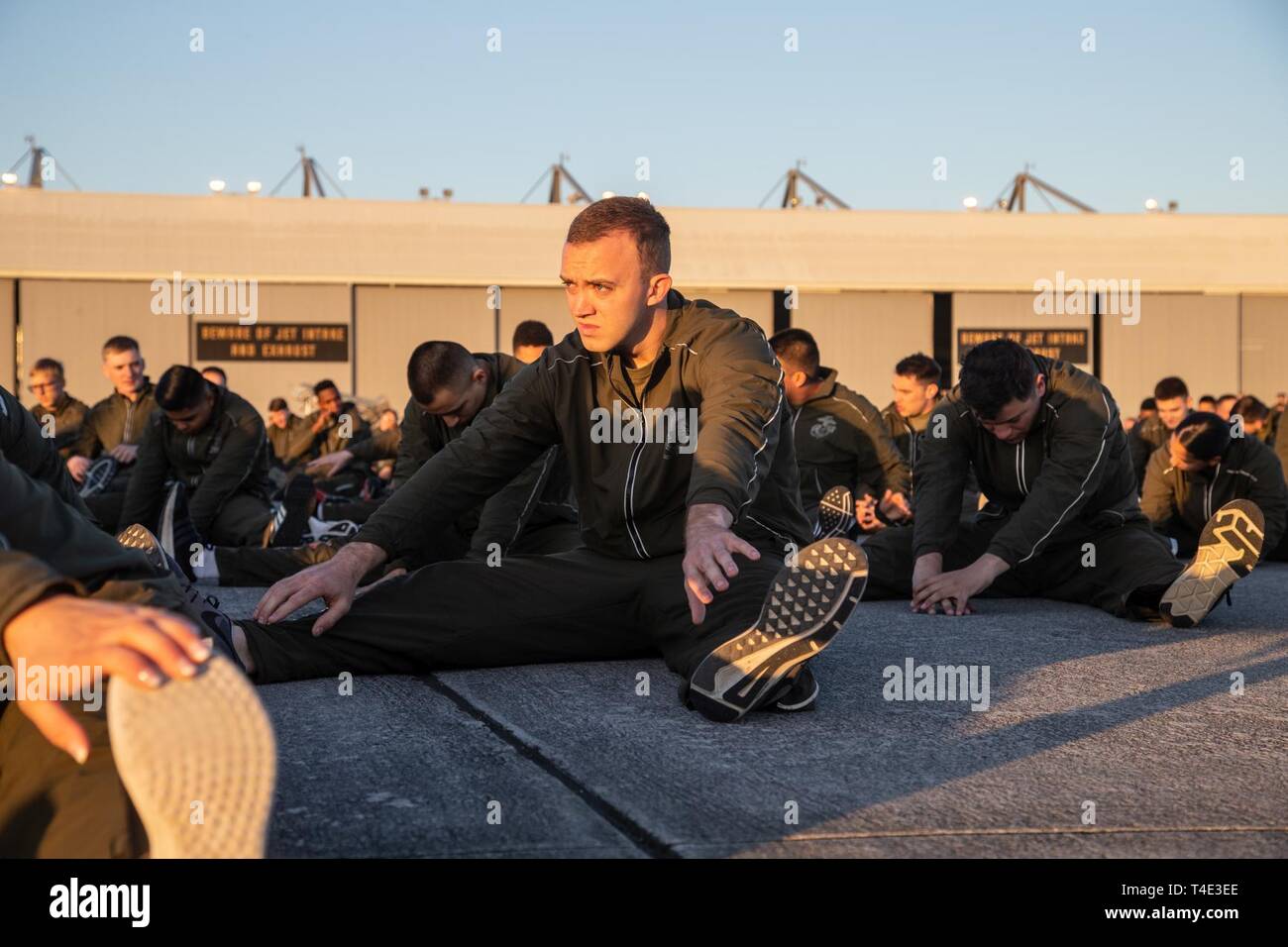 U.S. Marines perform lower body stretches prior to conducting unit ...