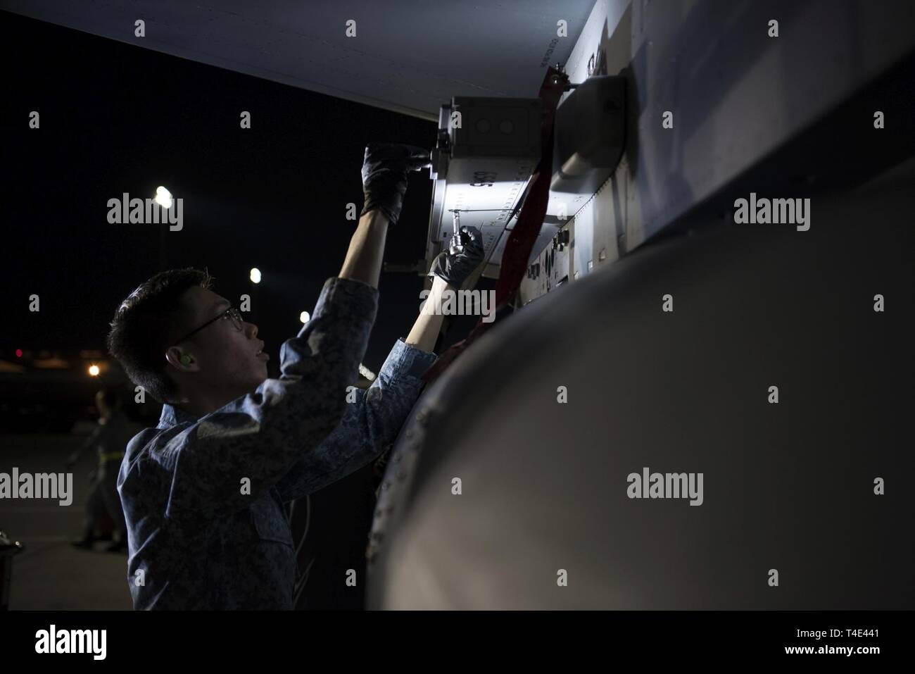 An airman from the 428th Fighter Squadron work on an F-15SG March 18 ...