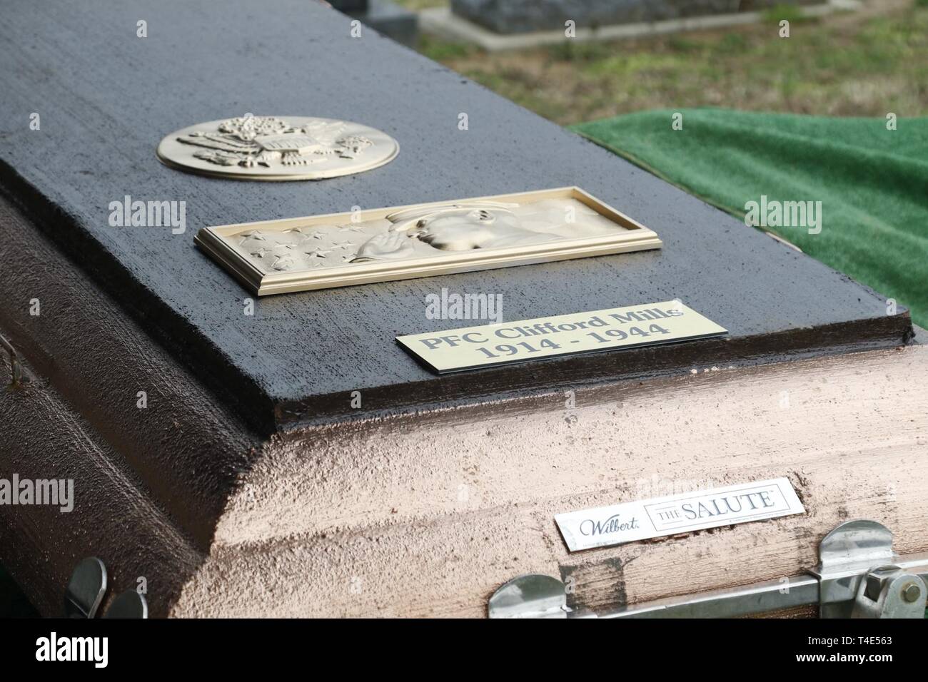 The casket vault of Clifford M. Mills rests above ground before being ...