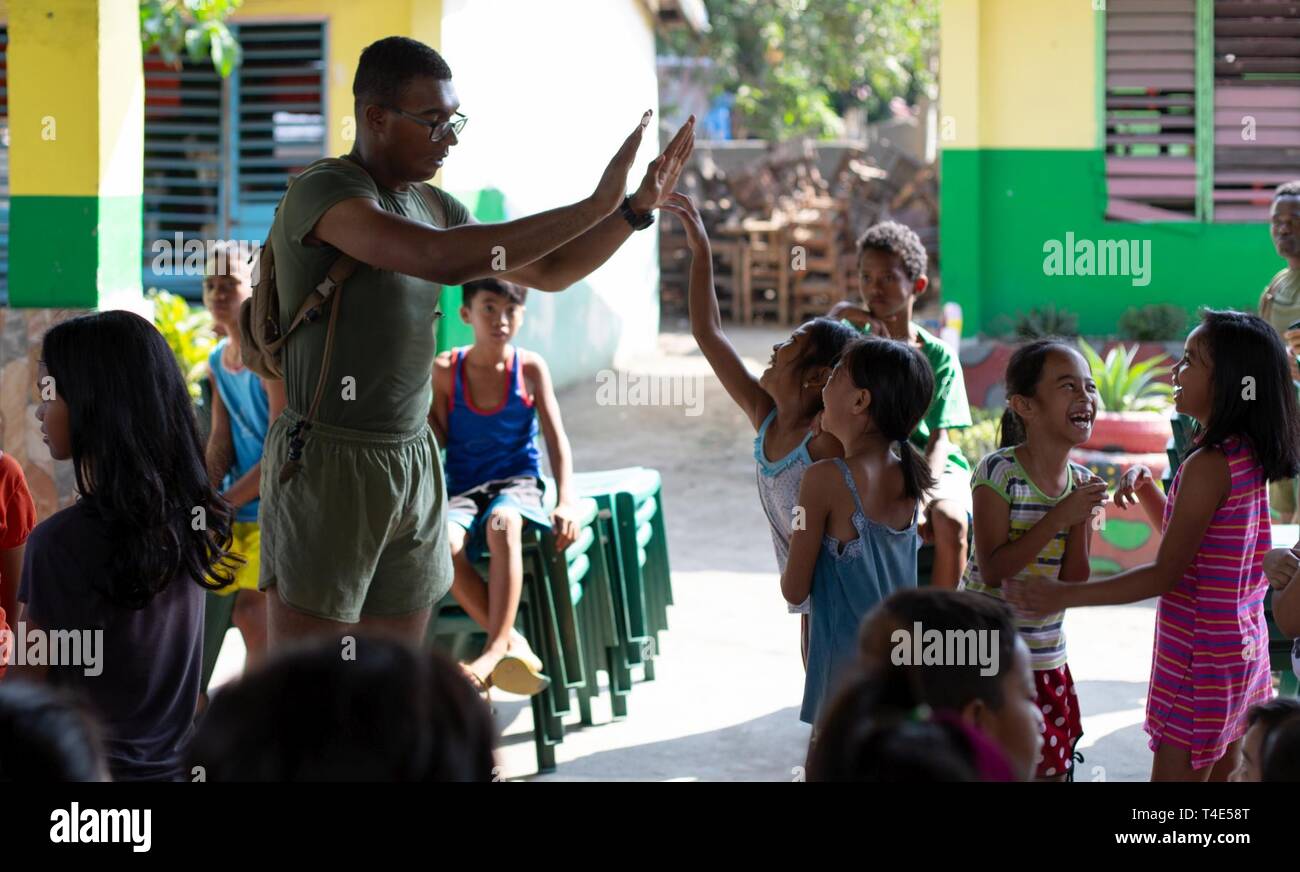 U.S. Marine Corps Lance Cpl. Nathaniel Singleton high-fives kids during ...