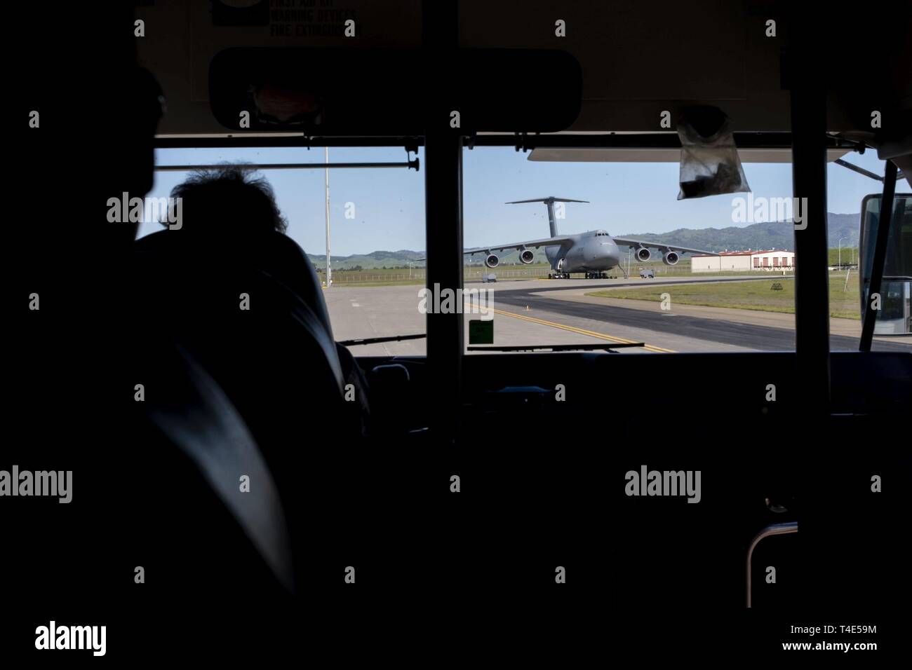 A C-5M Super Galaxy crew rides a bus to their aircraft March 30, 2019 ...