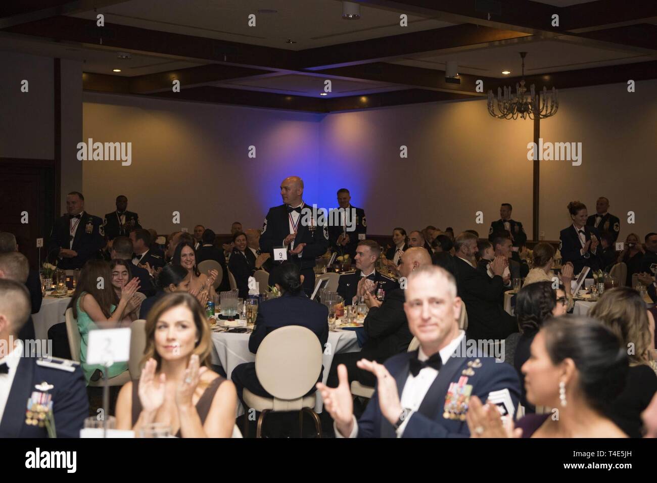 Guests attending the Chief Recognition Ceremony give a round of ...