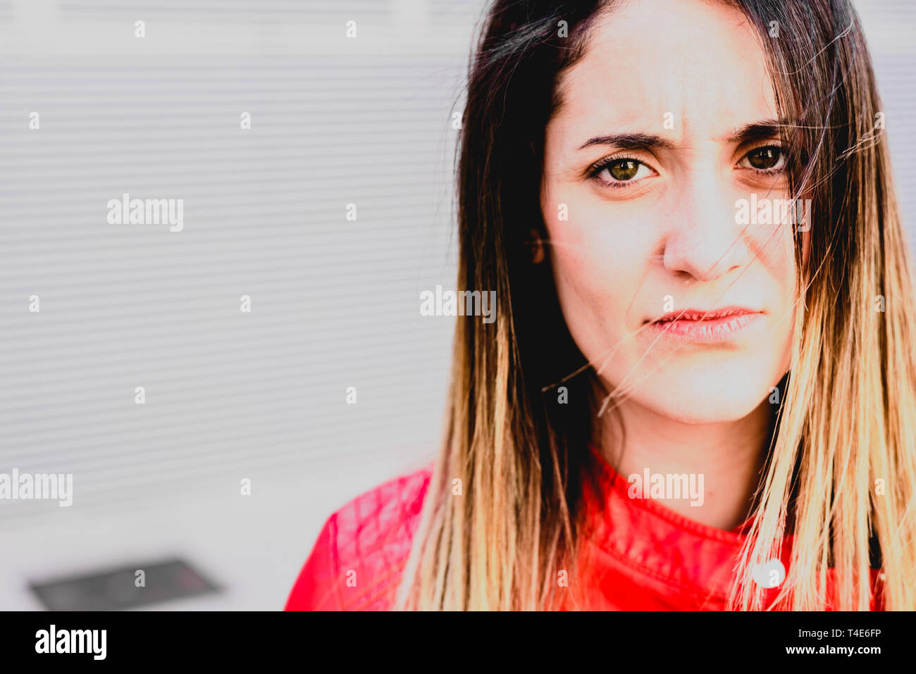 Portrait of young girl in red and blue clothes with proud attitude of ...