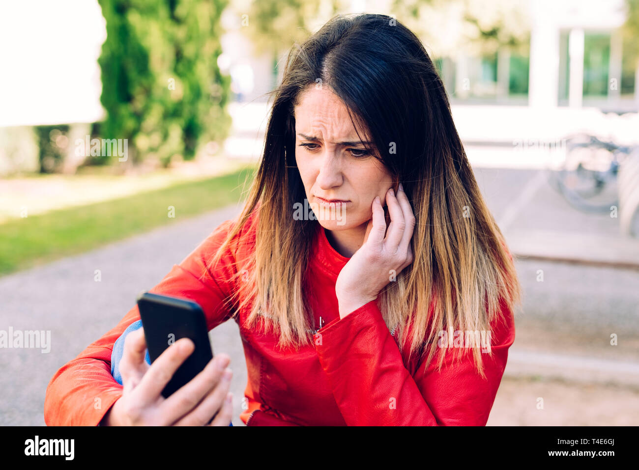 Young millennial student woman with a sad face when consulting her ...