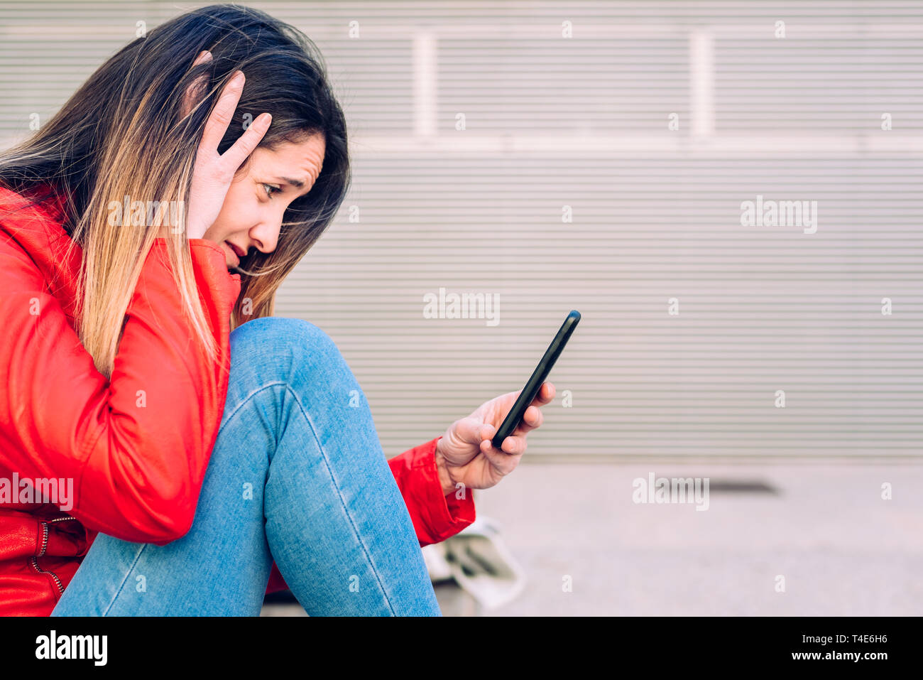 Young millennial student woman with a sad face when consulting her ...