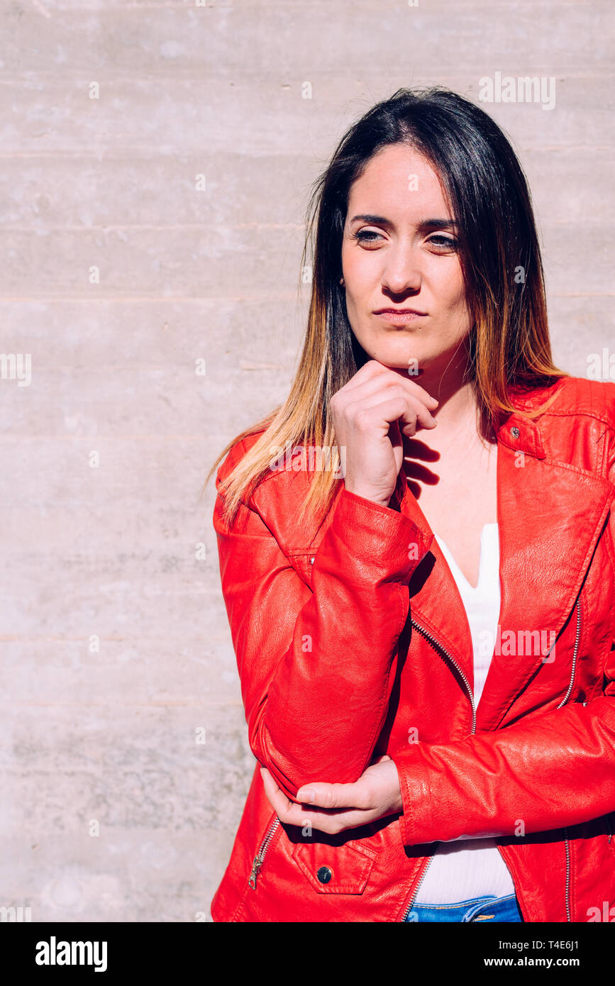 Portrait of young girl in red and blue clothes with proud attitude of ...