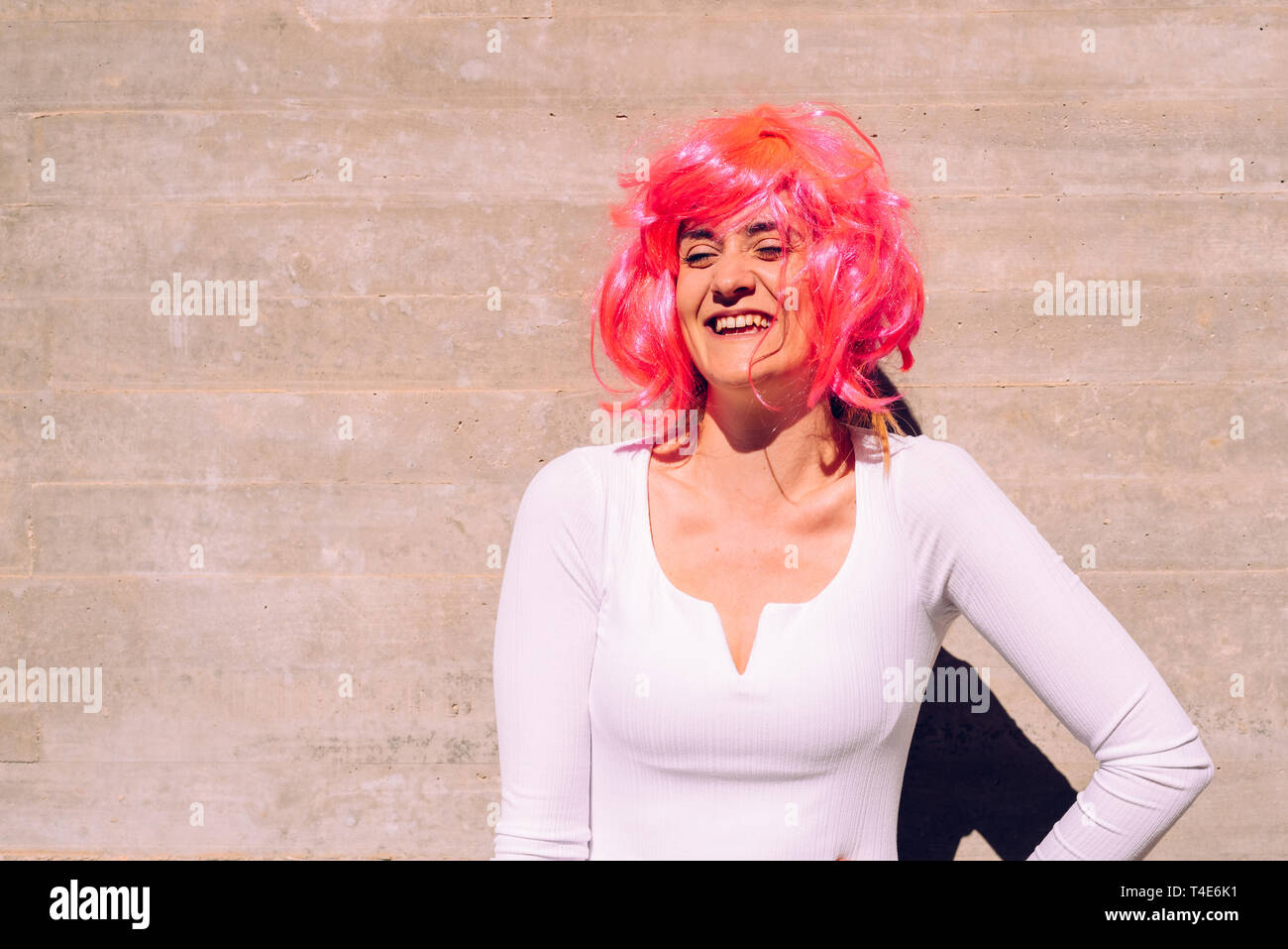 Slender and ugly woman with colorful wig posing ridiculously Stock ...