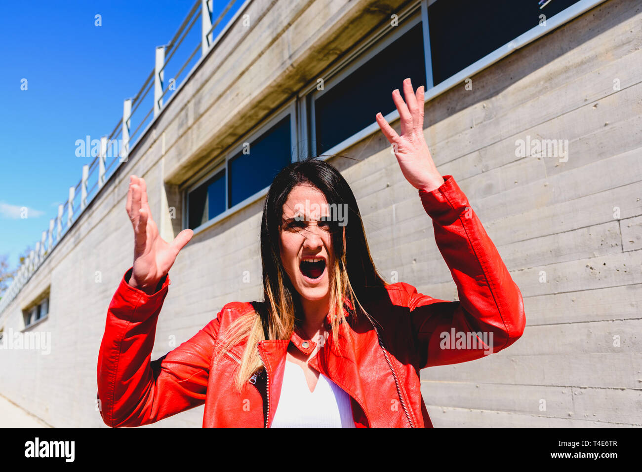 Scared woman is scared and makes a panic face while screaming for help ...