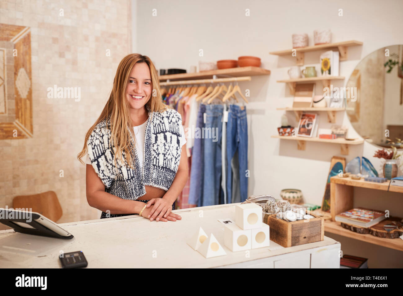 Portrait Of Female Owner Of Independent Clothing And Gift Store Behind ...