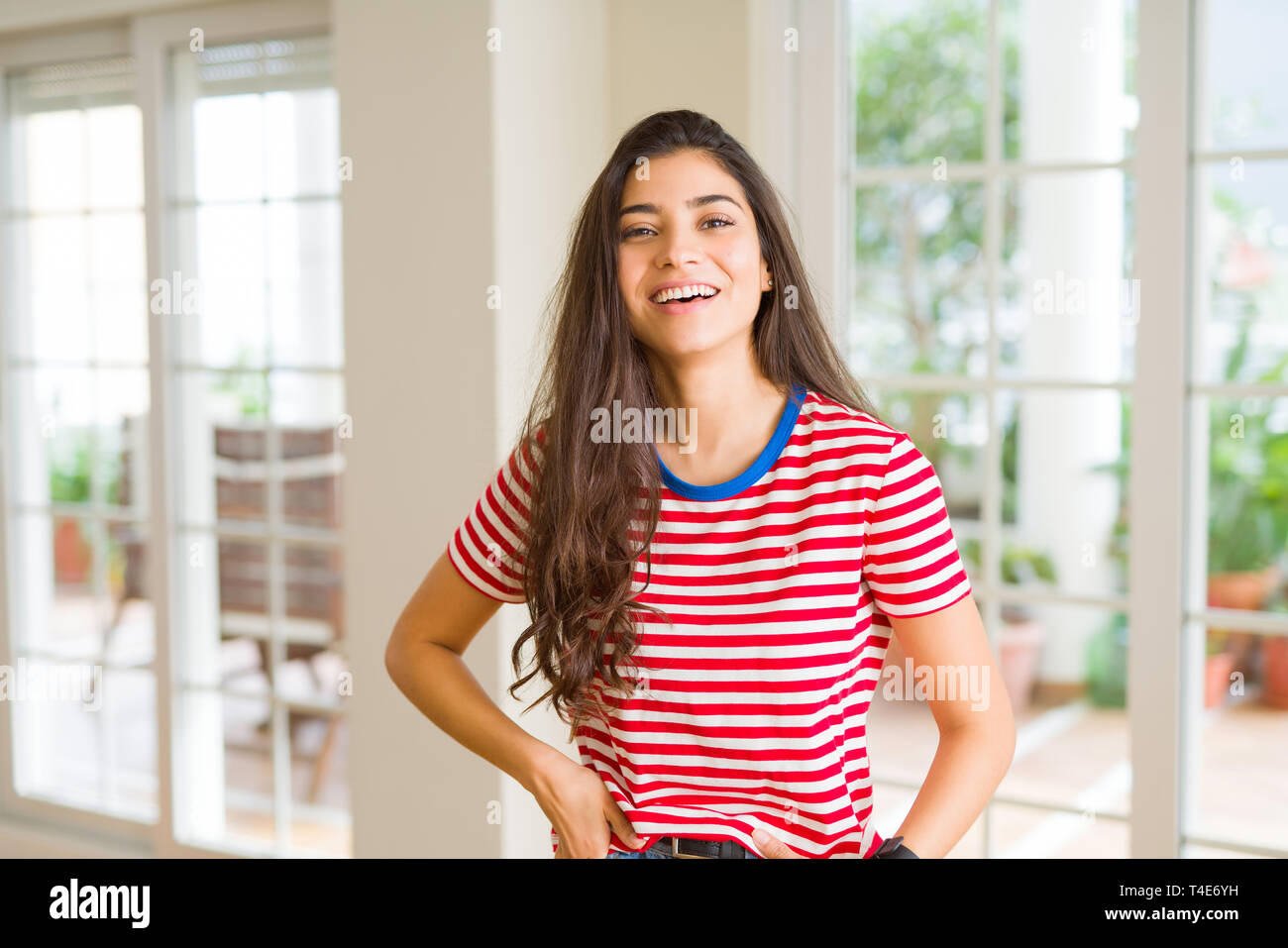 Beautiful brunette woman smiling cheerful, looking happy and positive ...