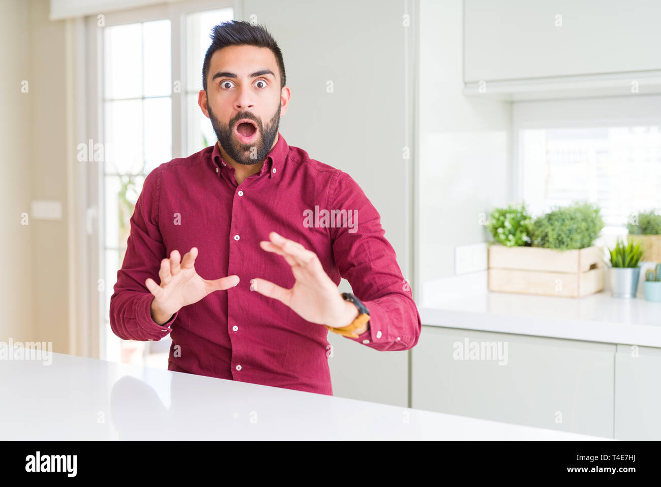 Handsome hispanic business man afraid and terrified with fear ...