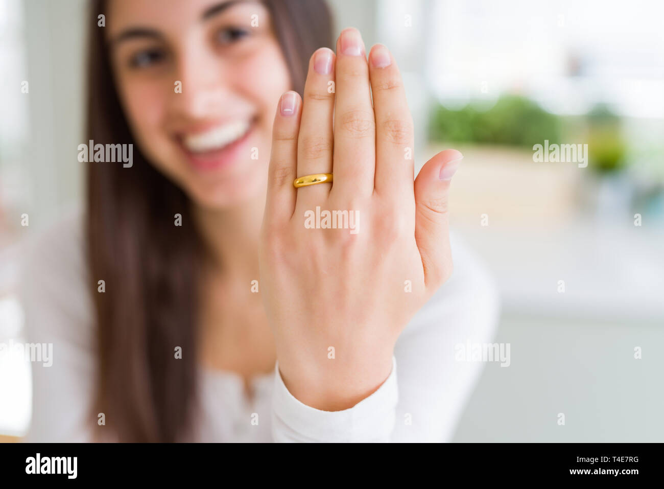Beautiful young woman showing hand wearing wedding alliance ring Stock ...
