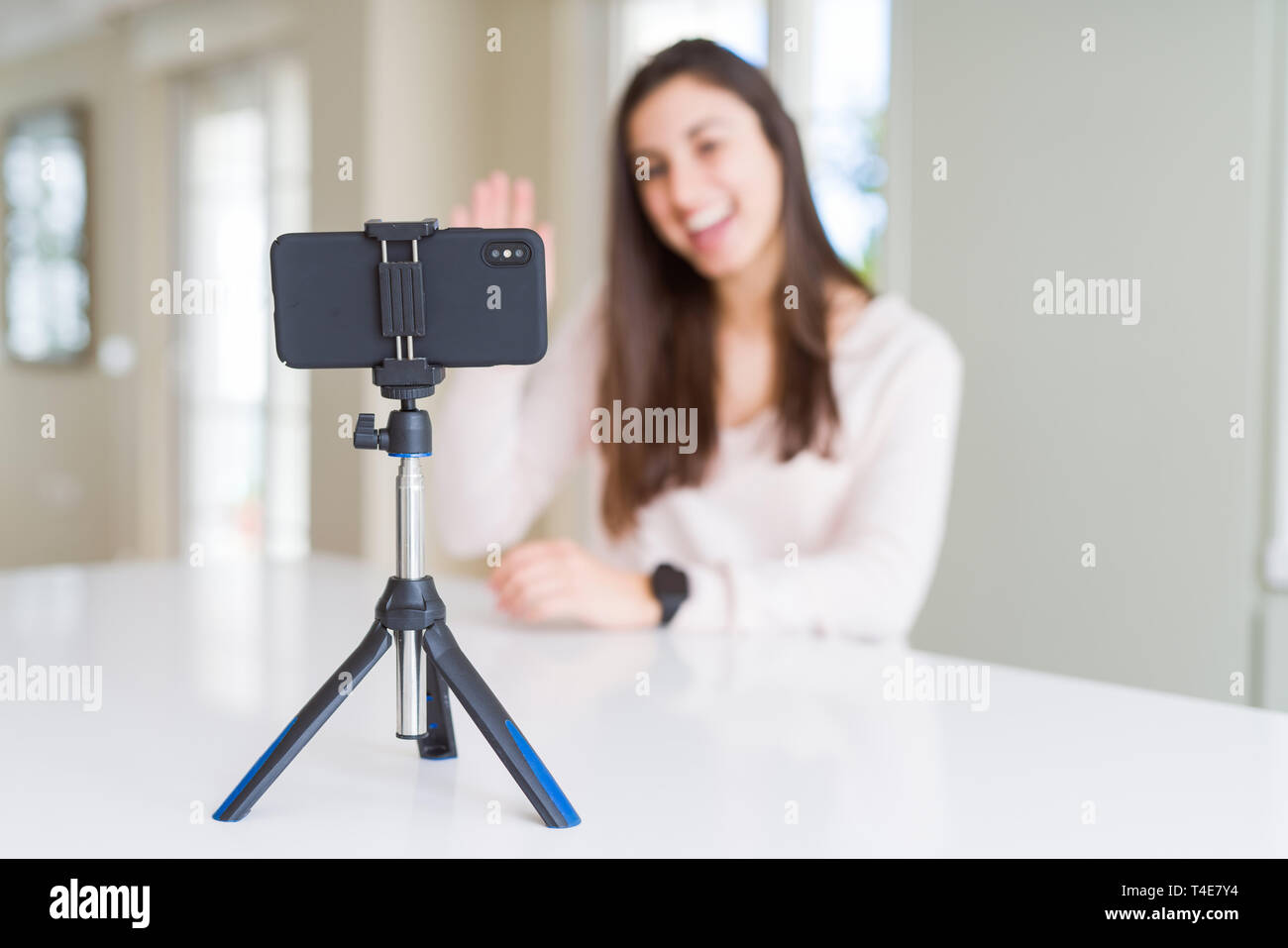 Beautiful young woman recording selfie video with smartphone webcam ...