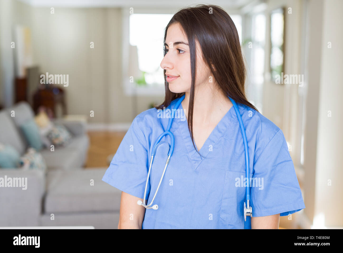 Beautiful young nurse woman wearing uniform and stethoscope at the ...