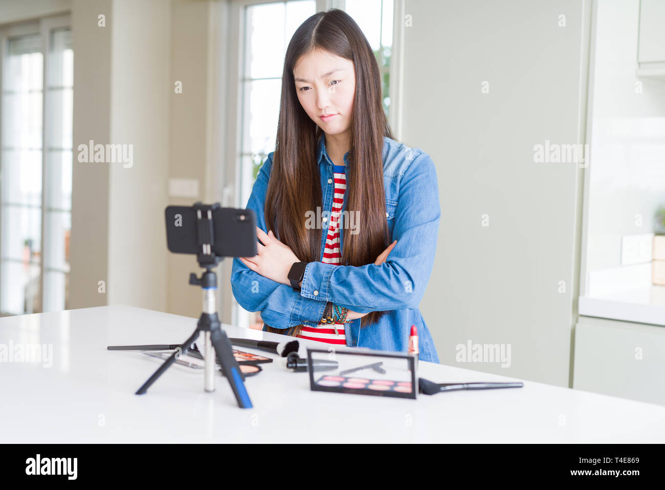 Beautiful Asian influencer woman recording make up tutorial using ...