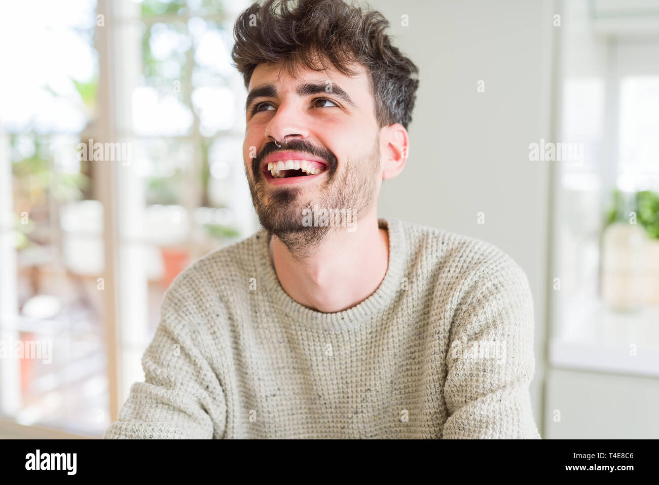 Handsome young man smiling cheerful at the camera with a big smile on ...