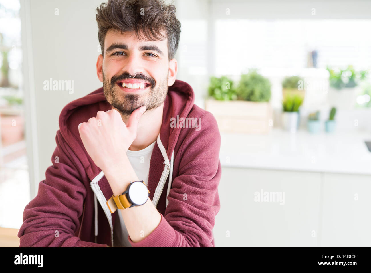 Handsome young man smiling cheerful at the camera with a big smile on ...