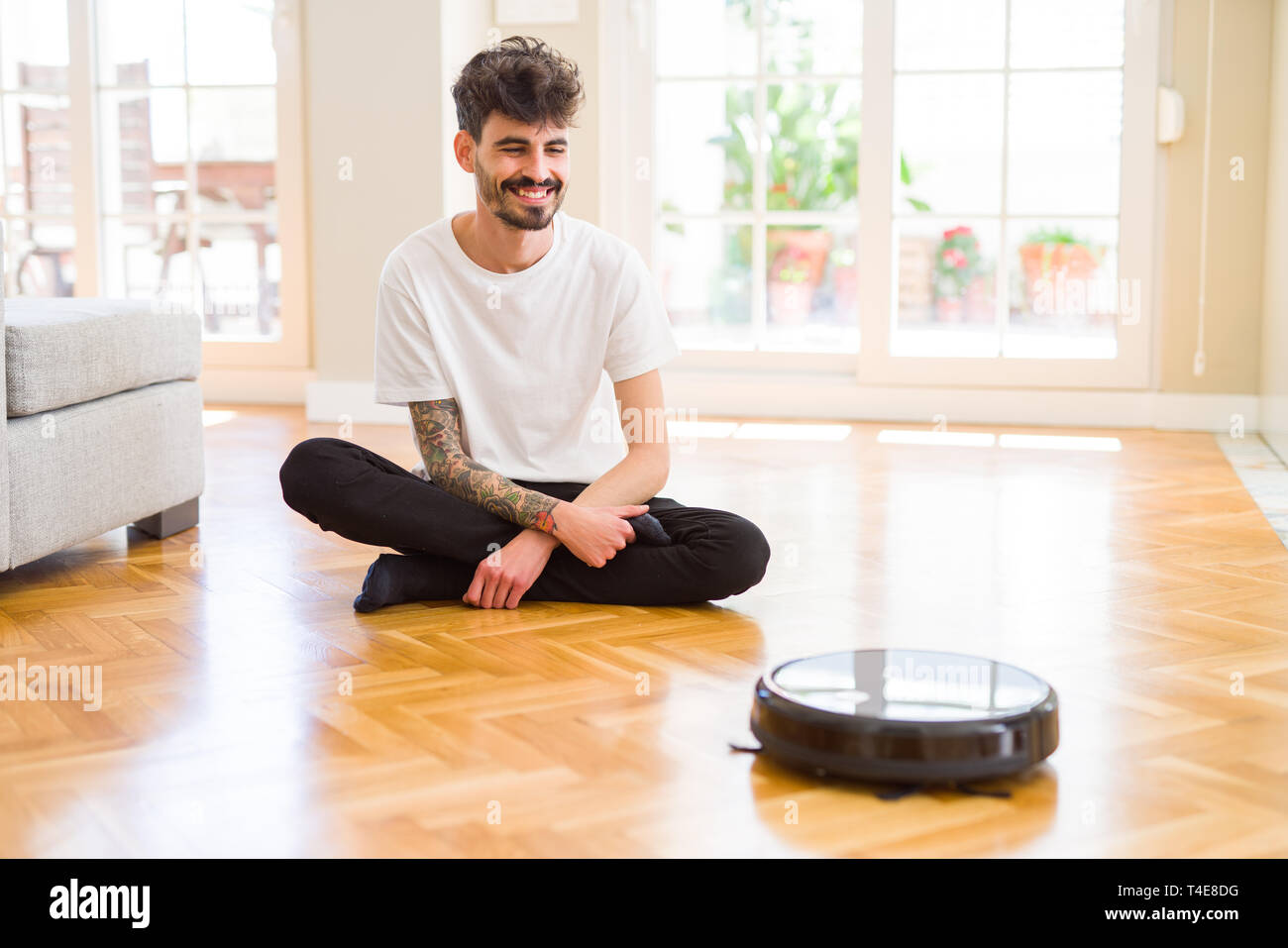 Happy smiling young man sweeping hi-res stock photography and images ...