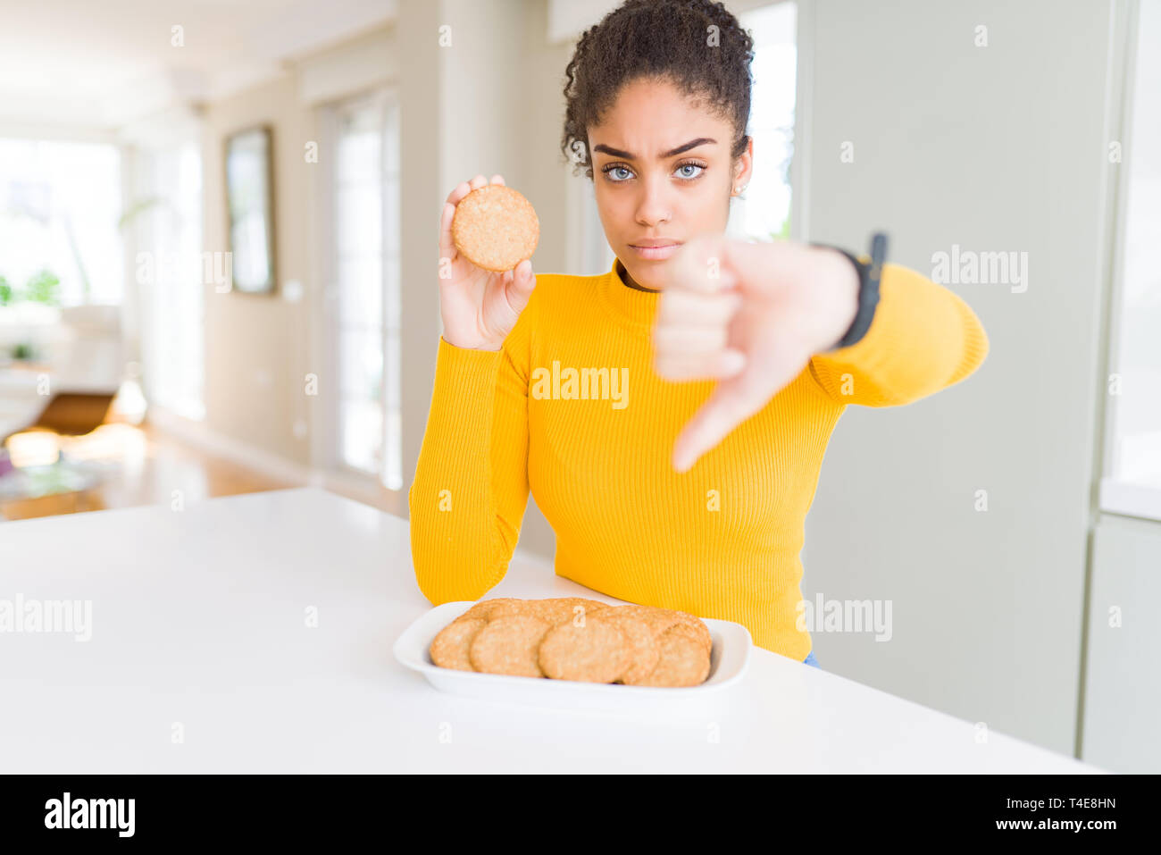 Young african american girl eating healthy whole grain biscuits with ...
