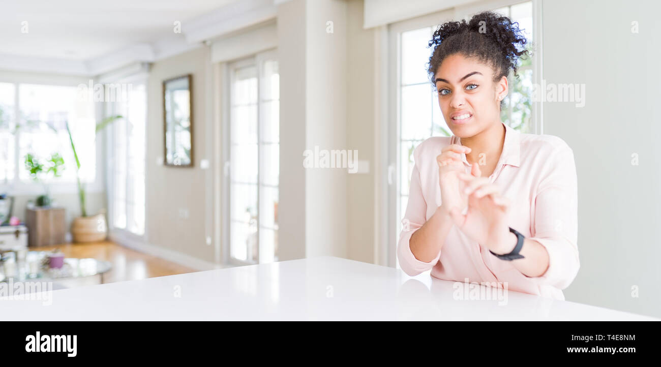 Wide angle of beautiful african american woman with afro hair disgusted ...