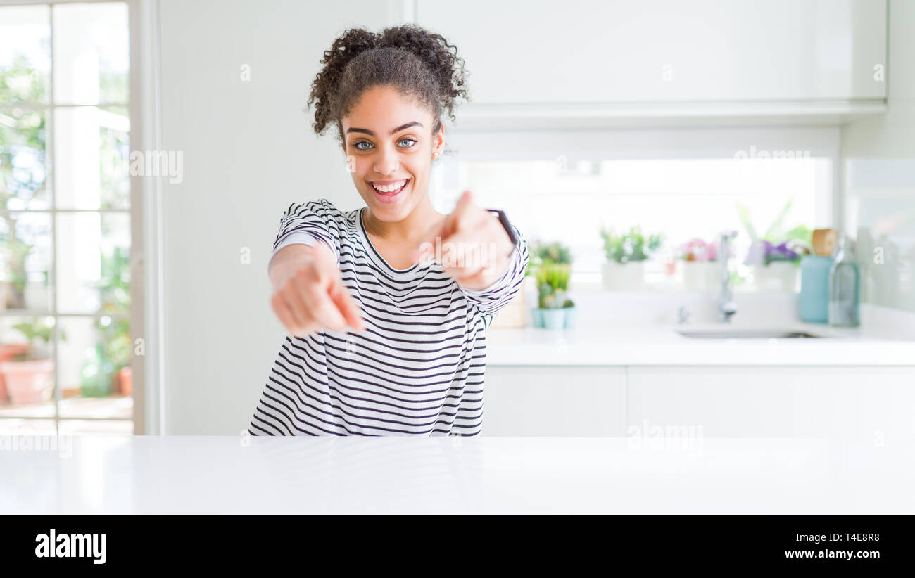 Beautiful african american woman with afro hair wearing casual striped ...
