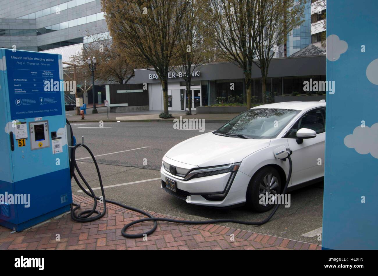 Electric cars sit outside of charging stations in downtown Portland, OR ...