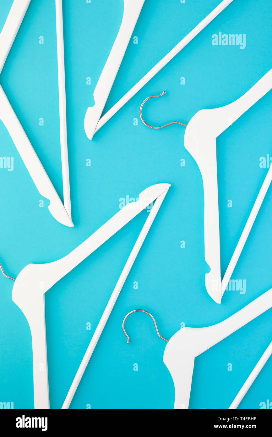Creative top view flat lay white wooden hangers isolated bold blue ...