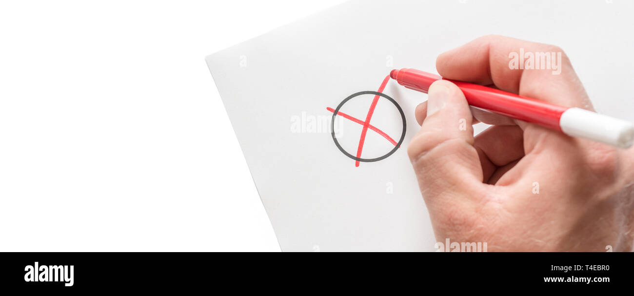 Man makes a cross on a piece of paper as a symbol of a choice with copy ...