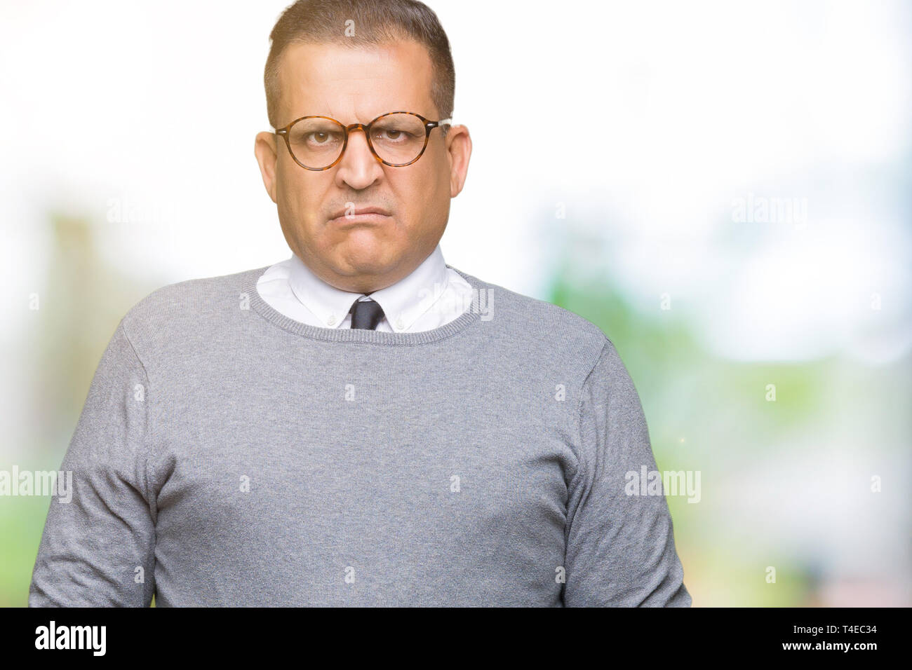 Middle age bussines arab man wearing glasses over isolated background ...