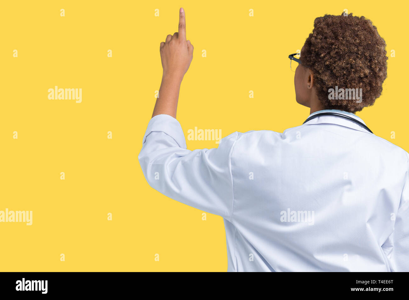 Young african american doctor woman wearing medical coat over isolated ...