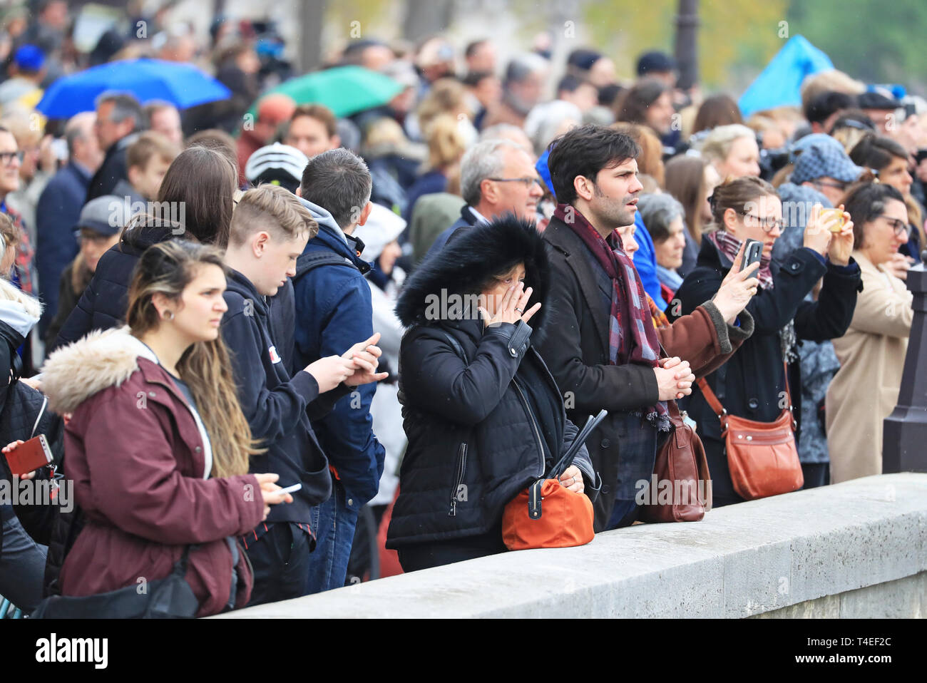 A crowd people look over towards remains notre dame cathedral hi-res ...