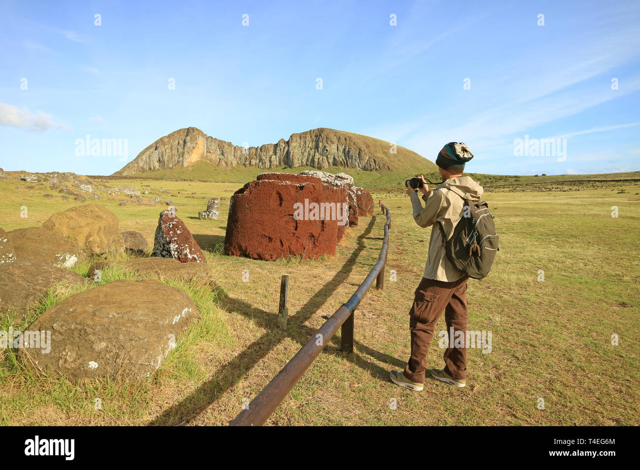 Man Photographing the Top Knots or Hat of Moai Statue Displaying on the ...