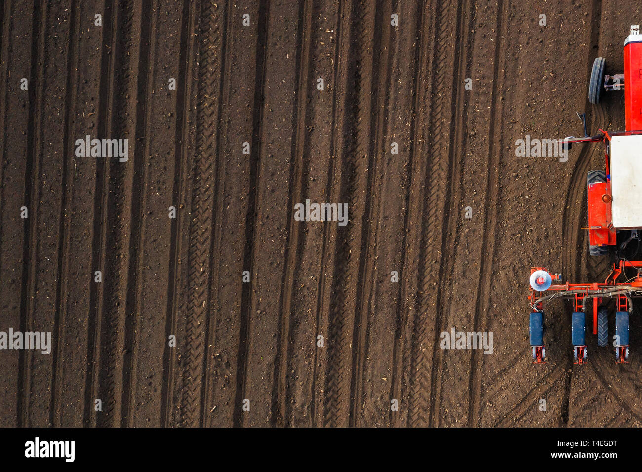Top view of tractor planting corn seed in field, high angle view drone ...