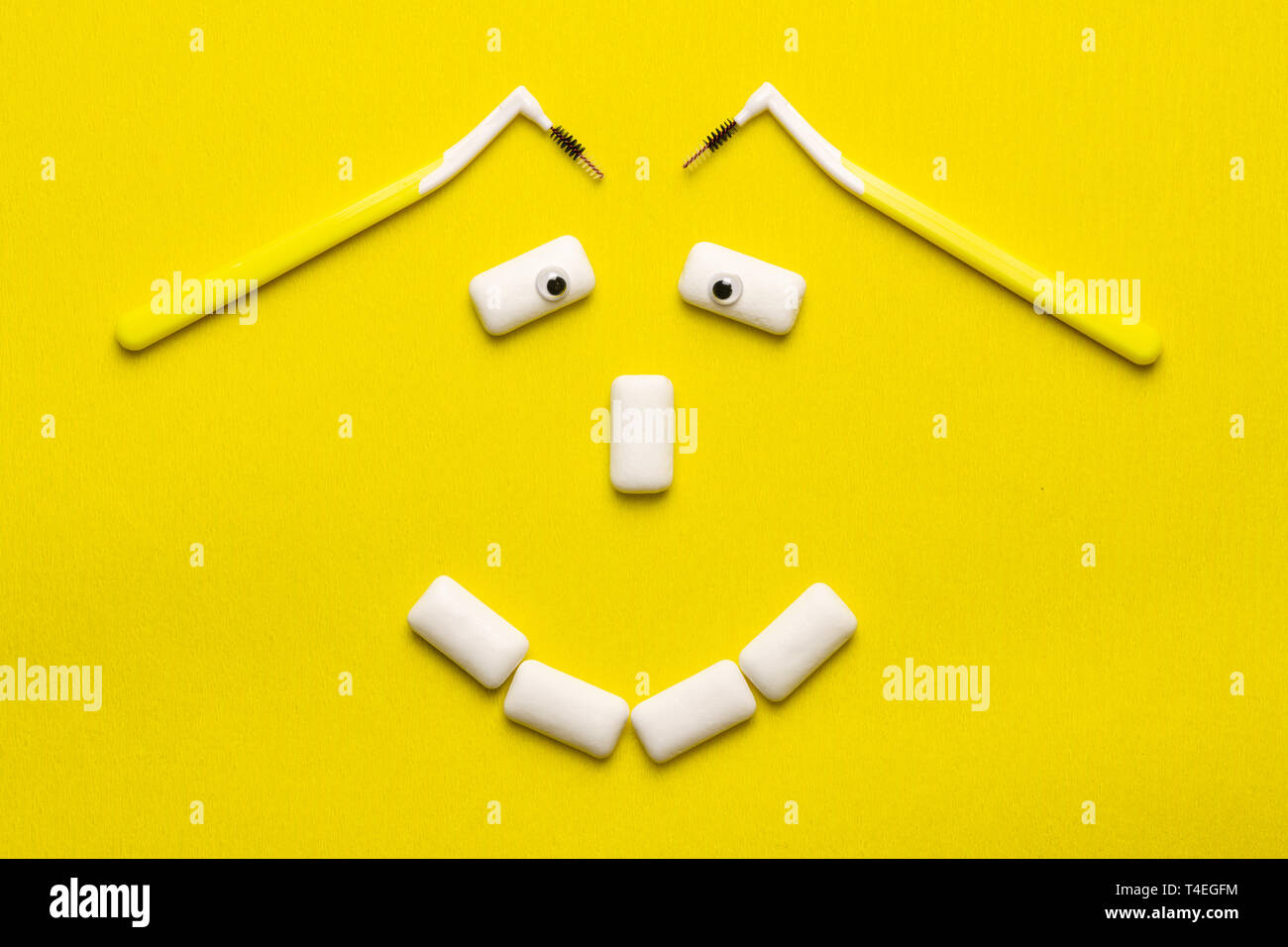 Braces cleaning concept with funny smile face shaped chewing gums pads ...