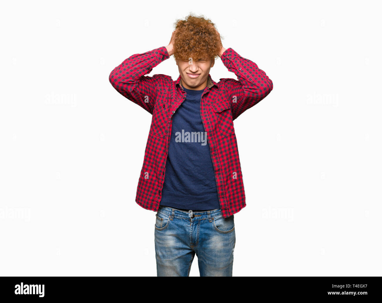 Young handsome student man with afro hair wearing a jacket suffering ...