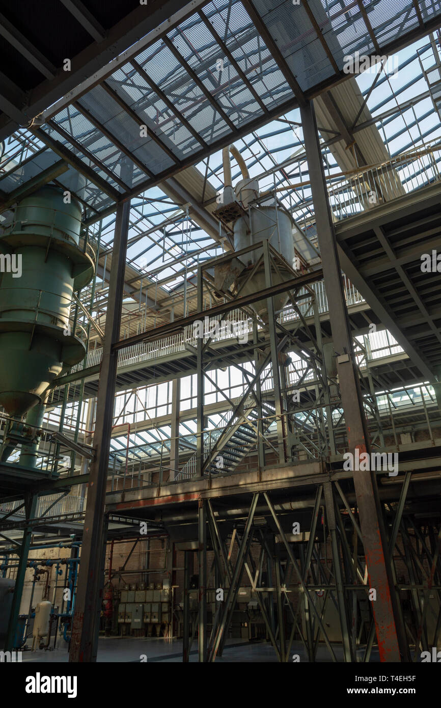 Industrial background, big old abandoned factory hall with stairs and ...
