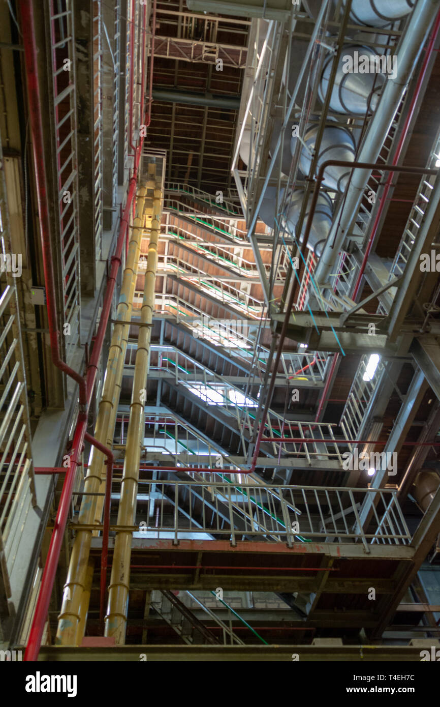 Industrial background, big old abandoned factory hall with stairs and ...