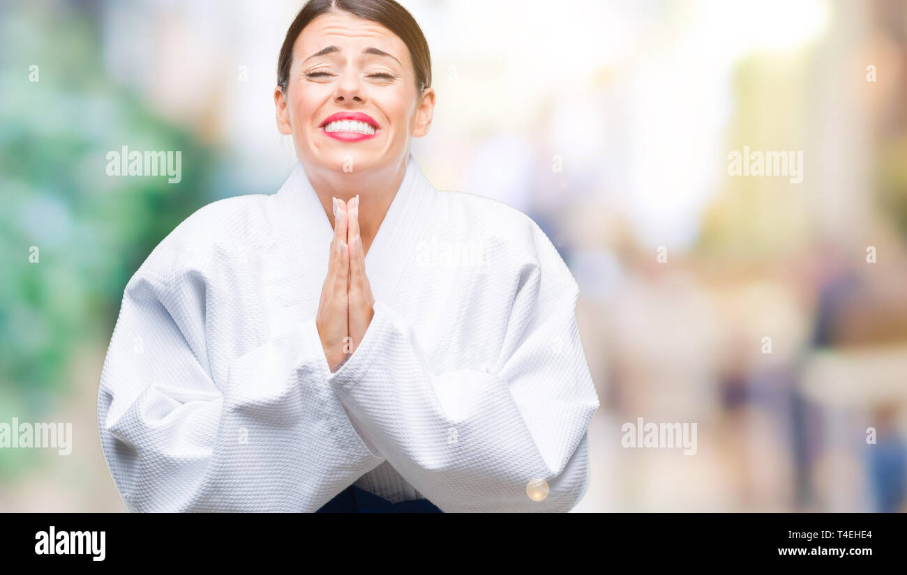 Young beautiful woman wearing karate kimono uniform over isolated ...